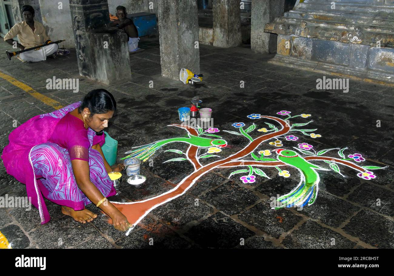 Drawing kolam, rangoli inside the temple floor, Sri Neelayadhakshi ...