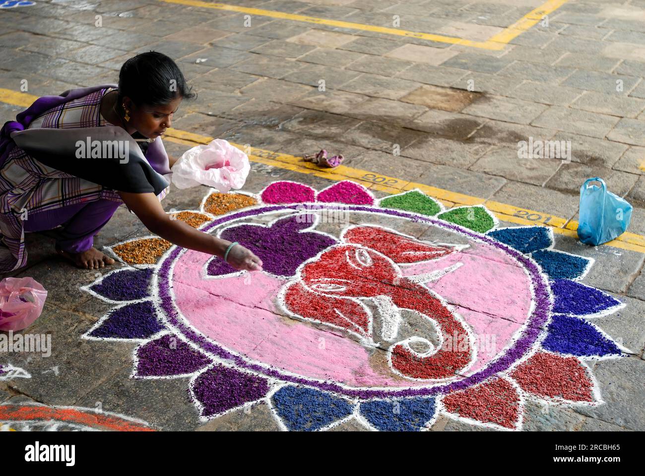 Drawing kolam, rangoli inside the temple floor, Sri Neelayadhakshi ...