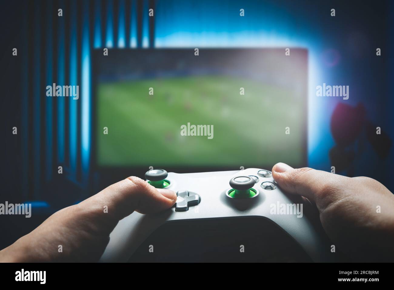 Video game controller, gaming concept with TV screen in background ...