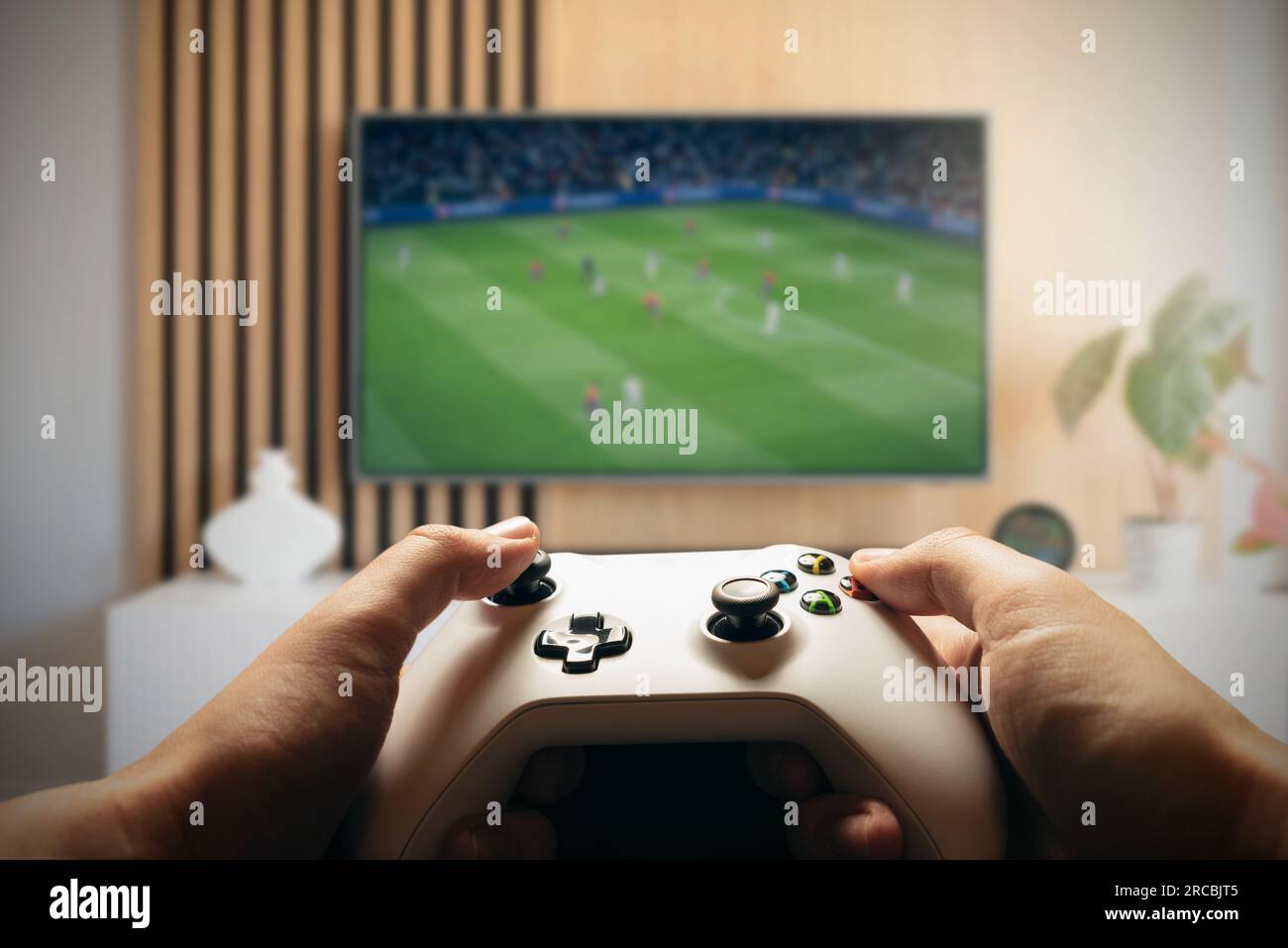 Video game controller, gaming concept with TV screen in background ...