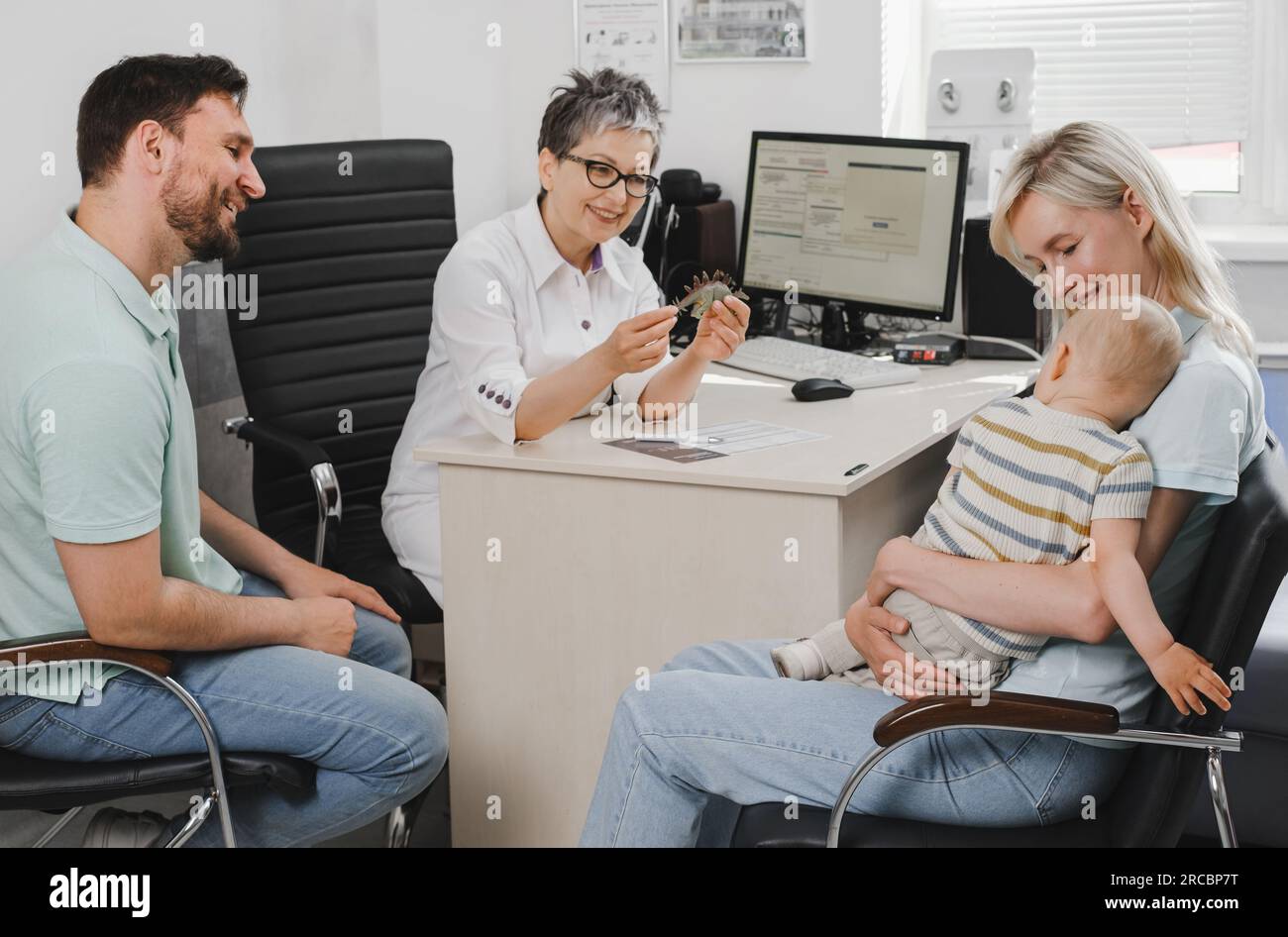 Family at kids hearing check-up. Parents with infant child consulting ...
