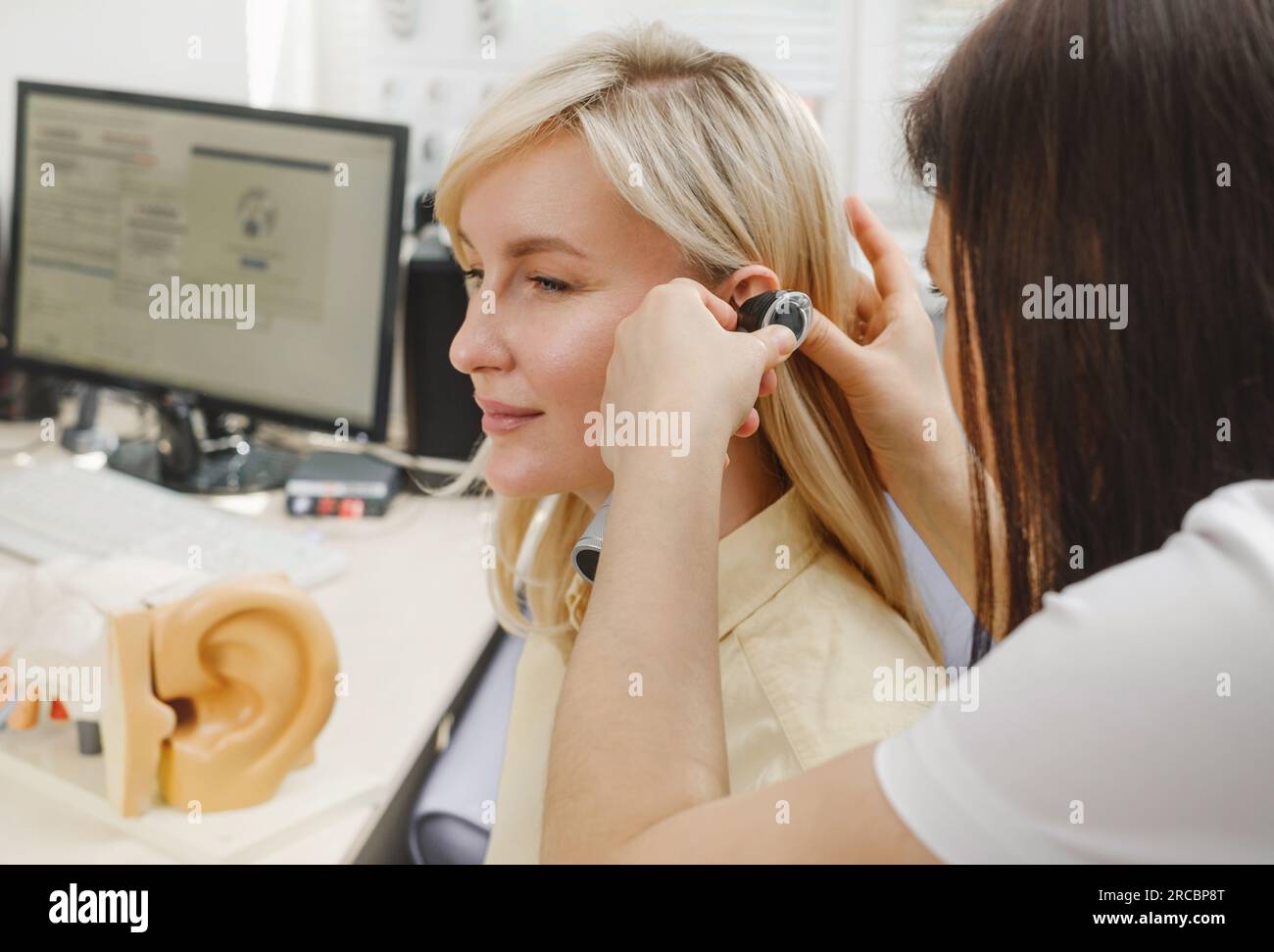 Woman patient having check-up of hearing at doctor otolaryngologist ...