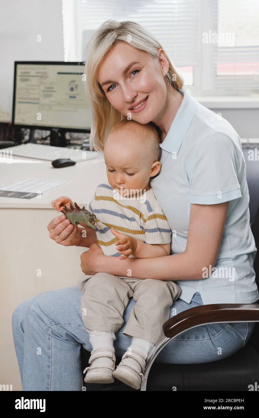 Woman with child consulting doctor for checkup. Parent with infant kid ...