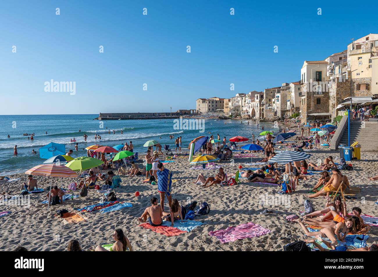The beach and Old Town in Cefalù on a sunny evening in July 2023 ...