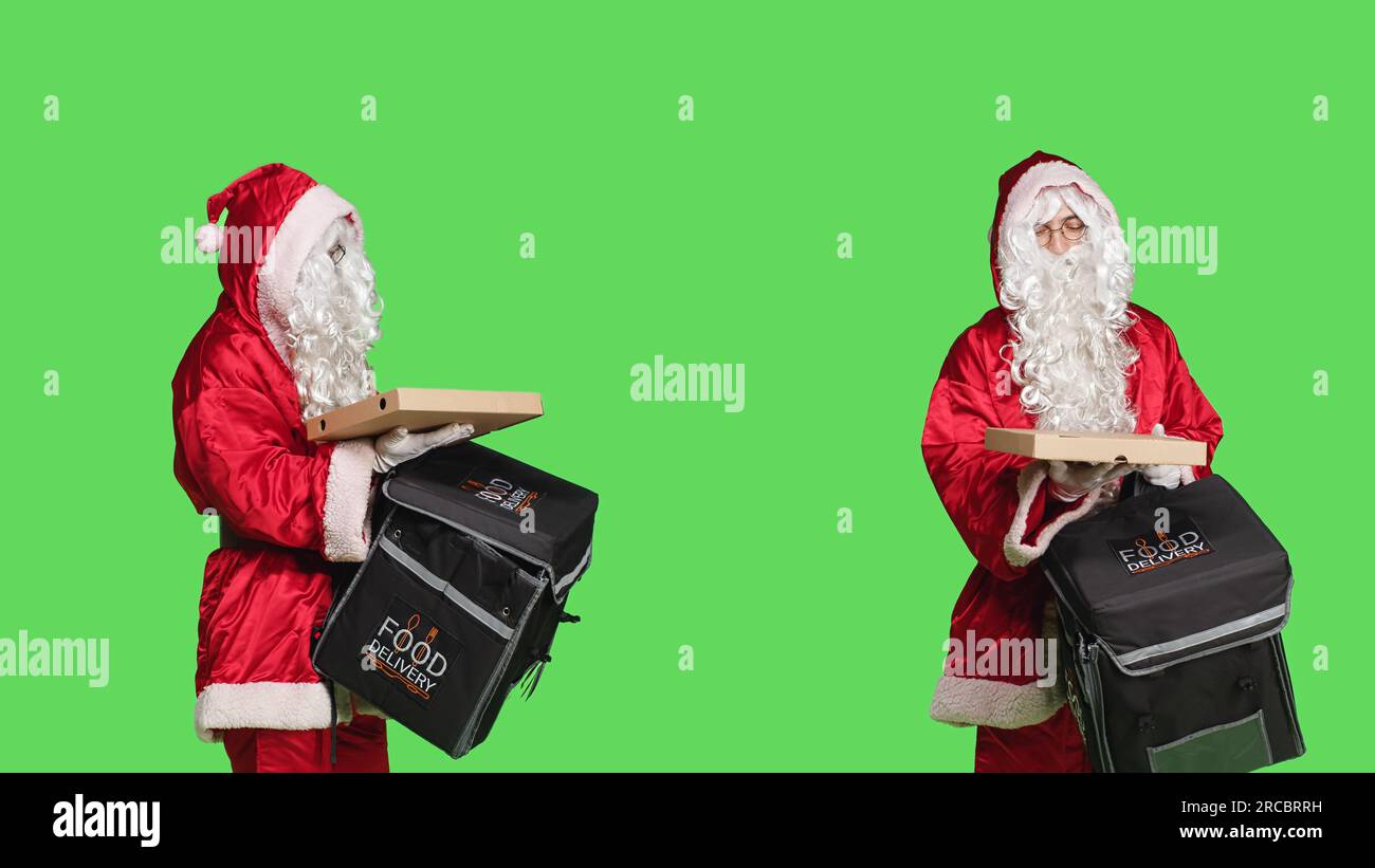 Deliveryman santa claus in character carrying thermal bag with fast ...