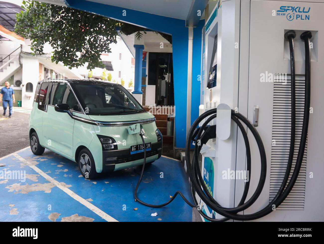 July 12, 2023, Malang, East Java, Indonesia: A electric car user is ...