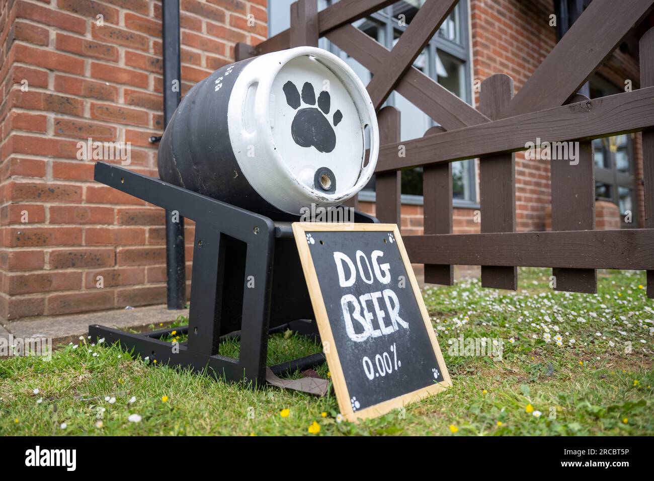 A sign advertising dog beer near a beer barrel at British pub in Wales ...