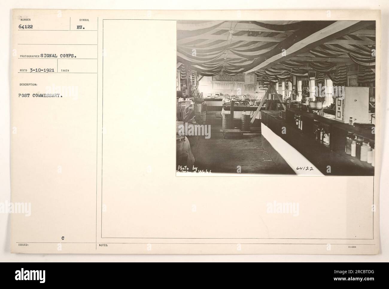 Image: The photograph depicts a bustling scene at a post commissary ...