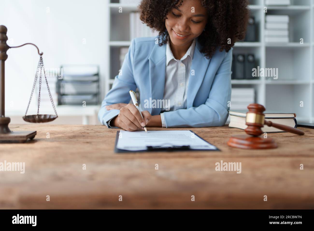 Young African American lawyer studying a case for a client and signing ...