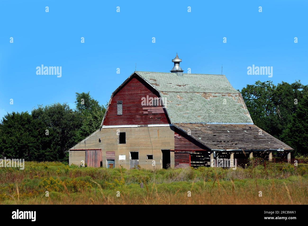 Kansas barn, builtt in 1911, has many patch work repairs. Metal vent is ...