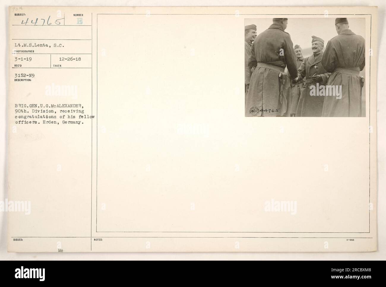 Brigadier General U.G. Me Alexander, of the 90th Division, receiving ...