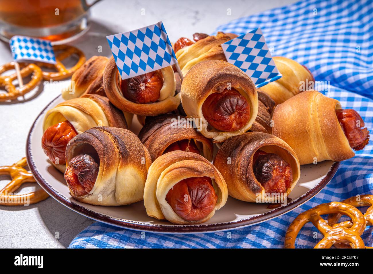 Oktoberfest party food. Pretzel hot dogs, puff pastry rolls with ...