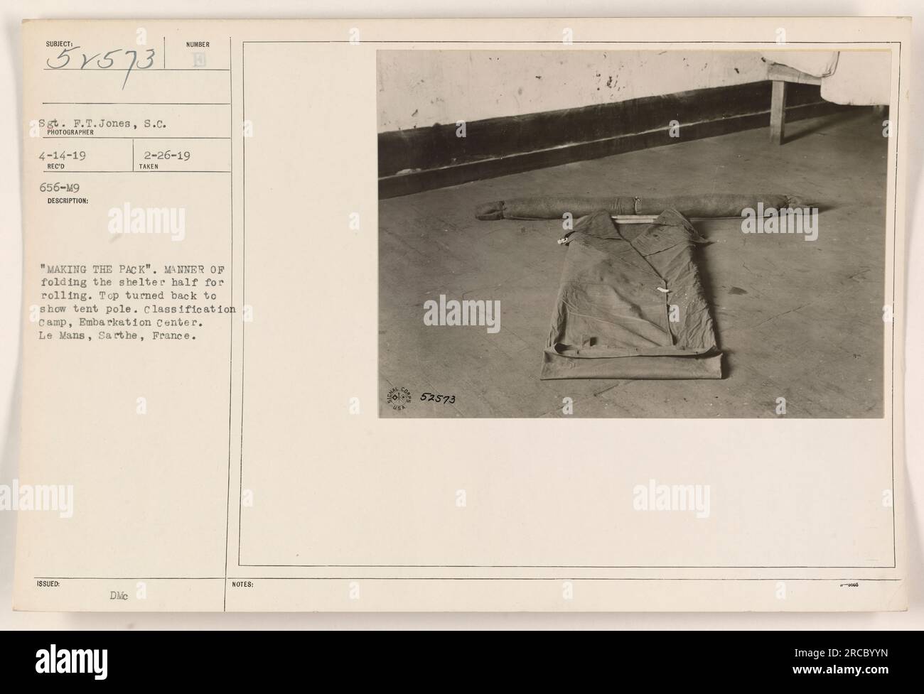 Soldier folding the shelter half for rolling, demonstrating the proper ...