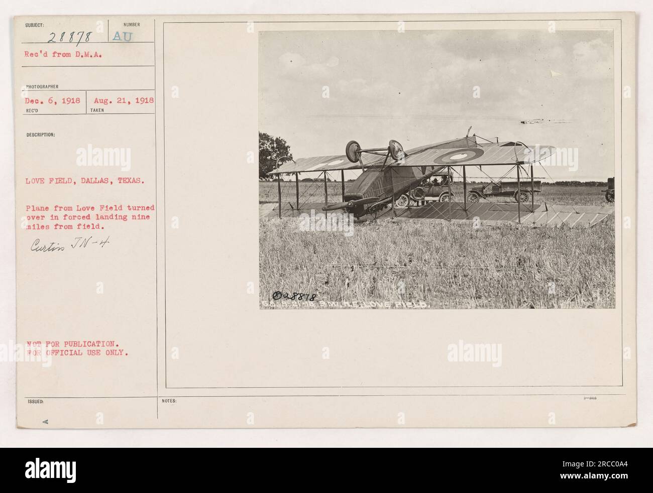 An image showing a Curtin JN-4 biplane turned over in a forced landing ...
