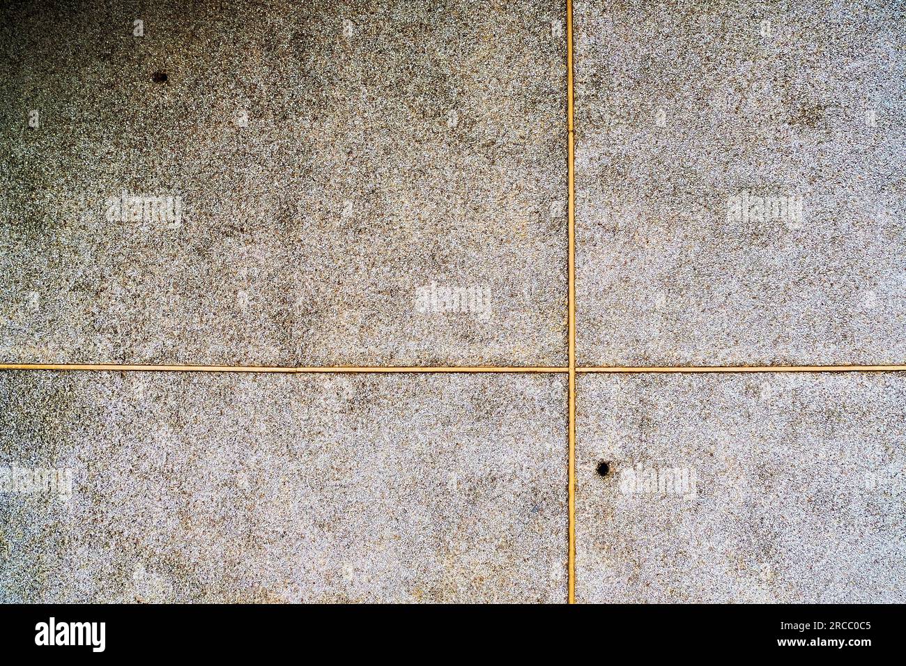 Graduated pebbledash coarse surface with two holes and crossing lines ...