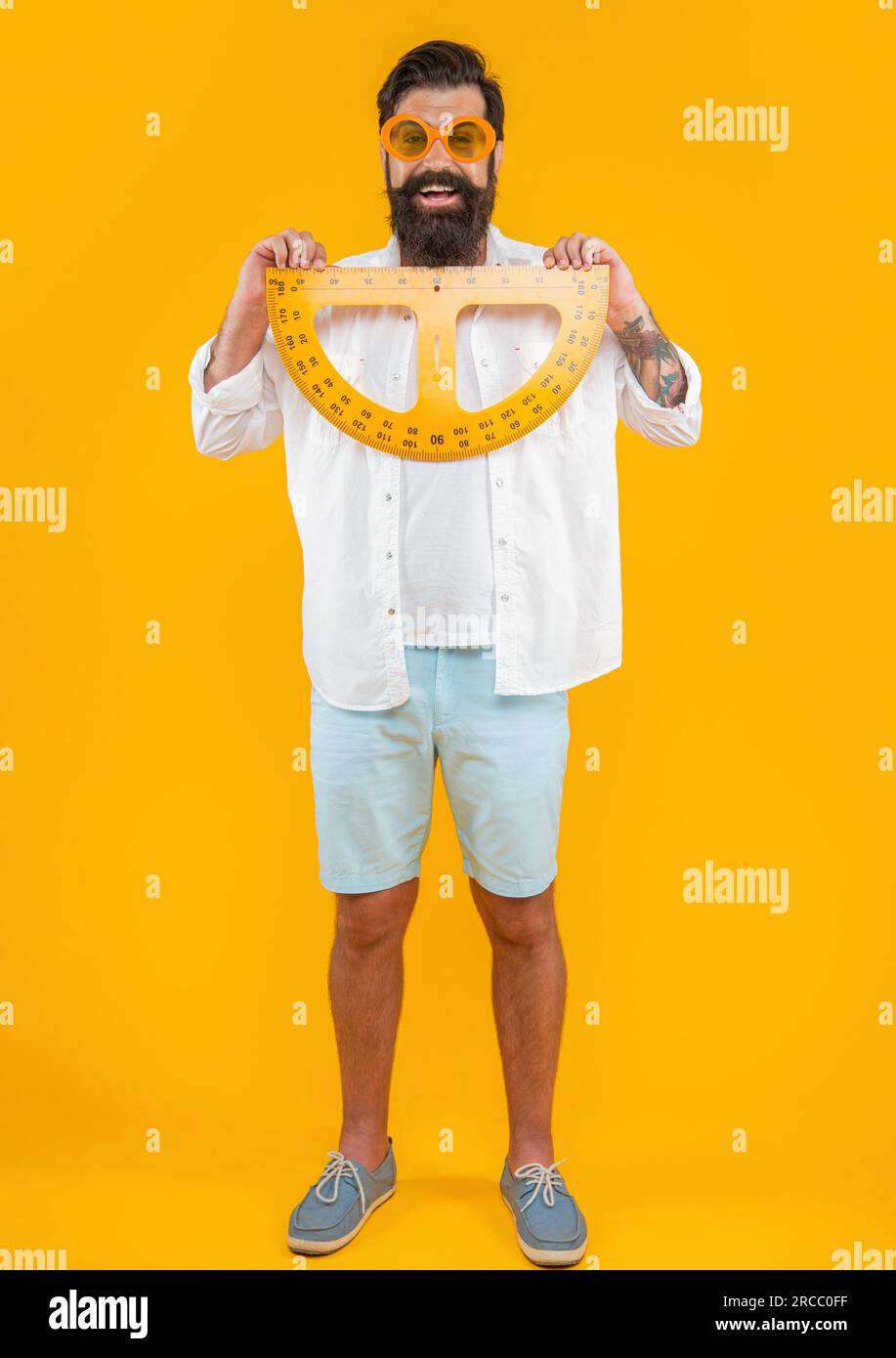 positive man hold geometry protractor isolated on yellow. man hold ...