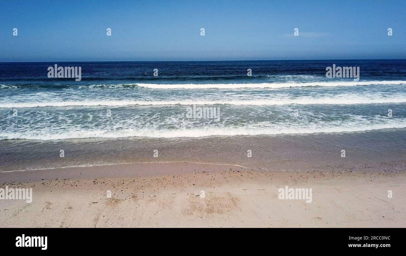 Aerial view of ocean waves crashing on beach, 4K drone footage Stock ...