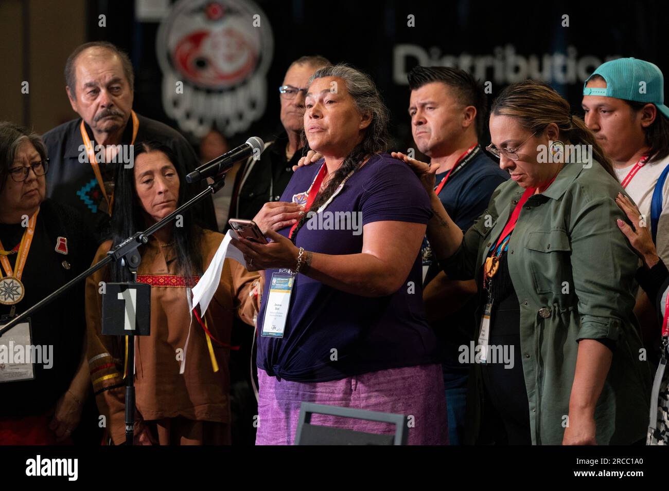 De-Anne Sack, centre, of Sipekne‚Äôkatik First Nation, reads a poem in ...