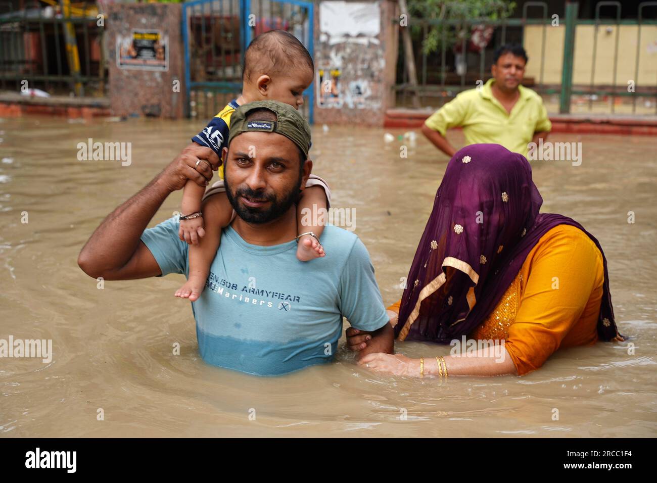 New Delhi, India. 13th July, 2023. People from low lying areas around ...