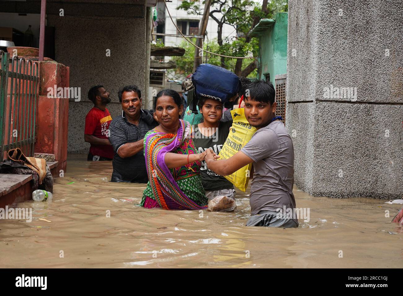 New Delhi, India. 13th July, 2023. People from low lying areas around ...