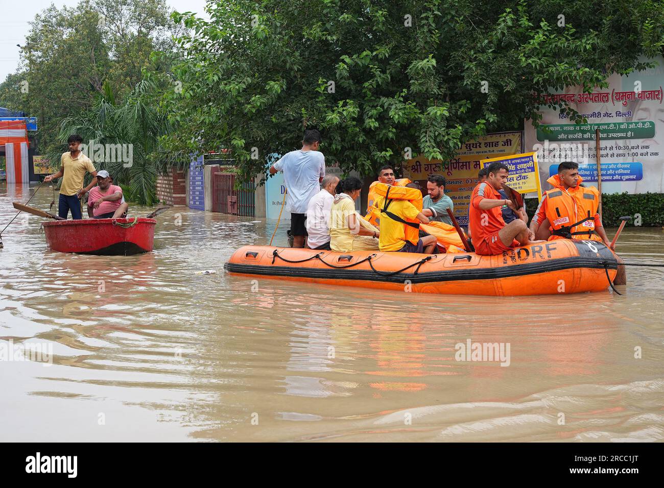 New Delhi, India. 13th July, 2023. Local people and NDRF team rescue stuck in low lying areas ...