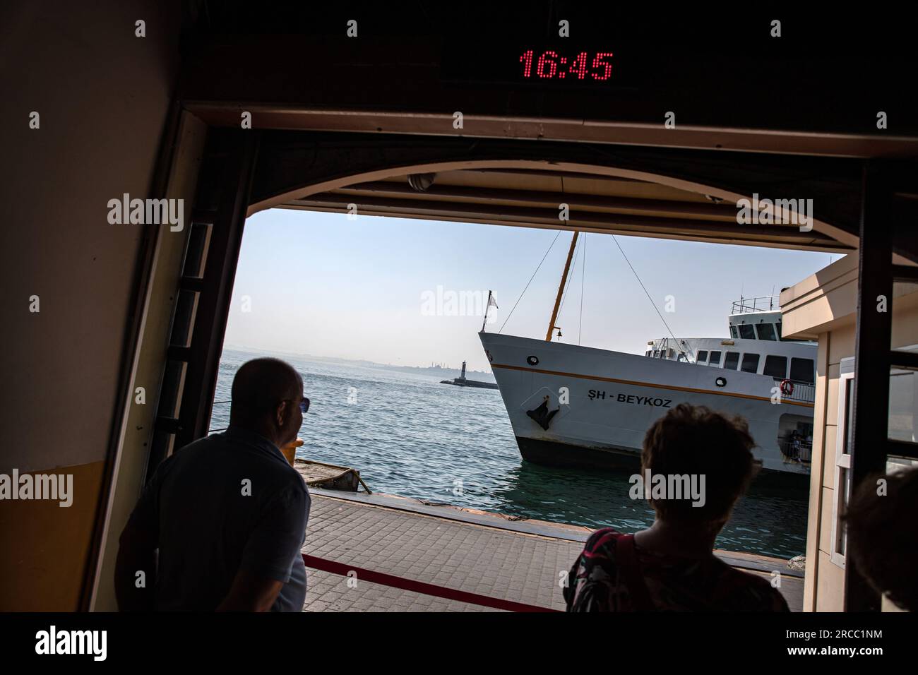 Istanbul, Turkey. 13th July, 2023. People wait to board a ferry docking at the Kadikoy city ...