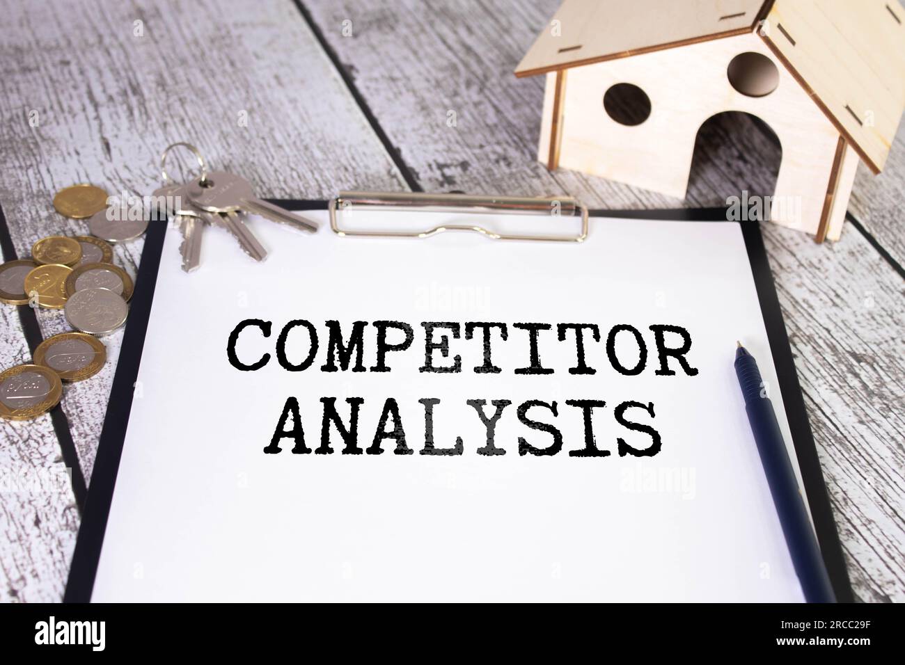 COMPETITOR ANALYSIS text on a paper with keyboard, calculator on a grey ...