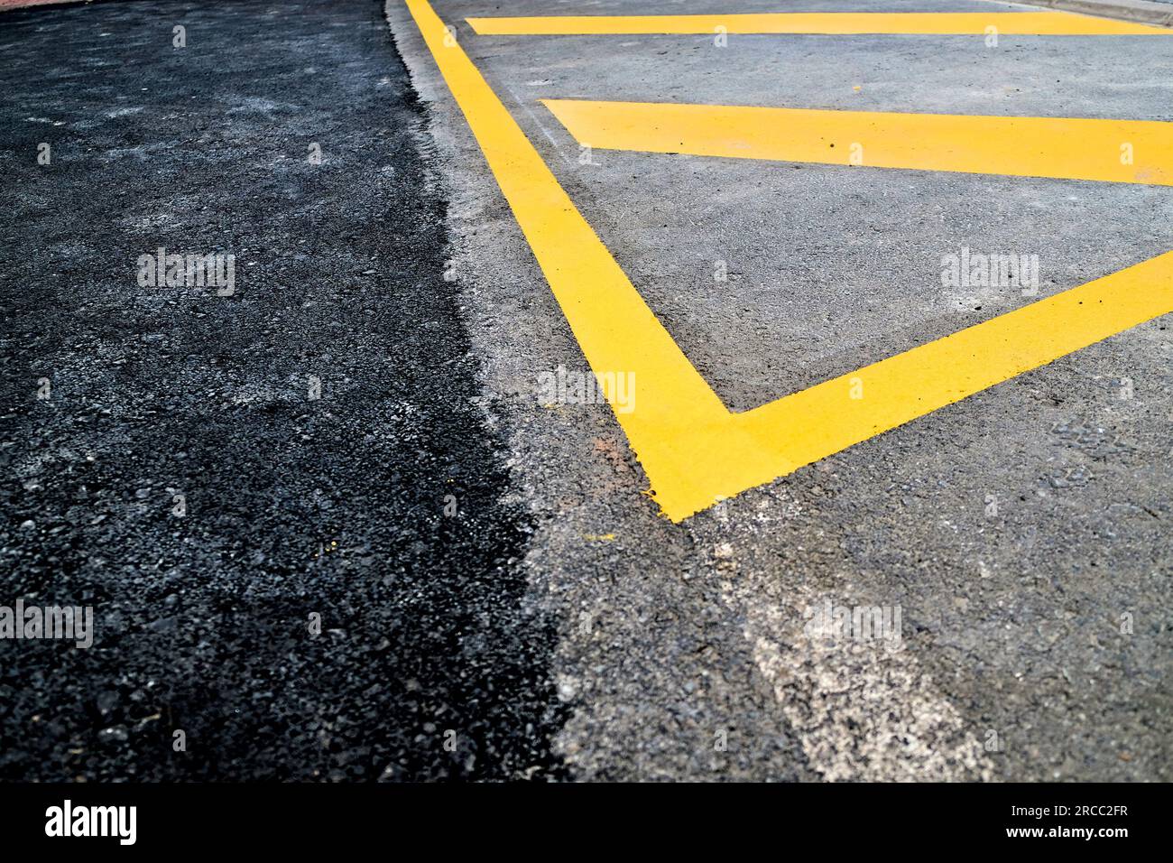 Abstract detail of city parking area - yellow road signage on road ...