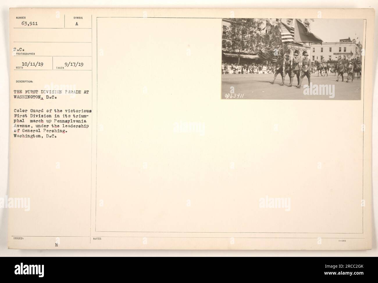 The image shows the Color Guard of the First Division parading in ...