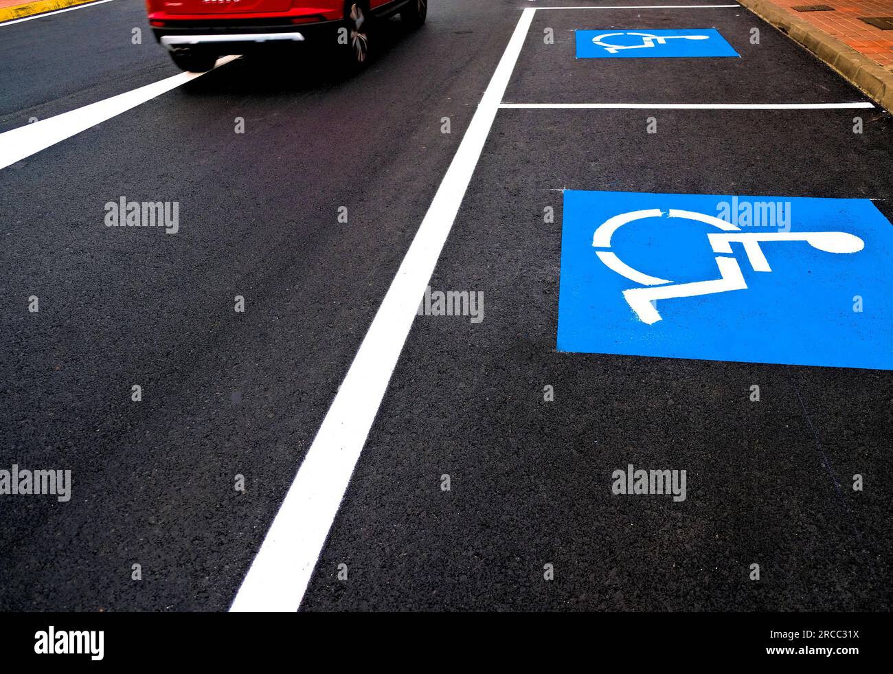 International Symbol of Access marking a parking lot, fragment of a red ...