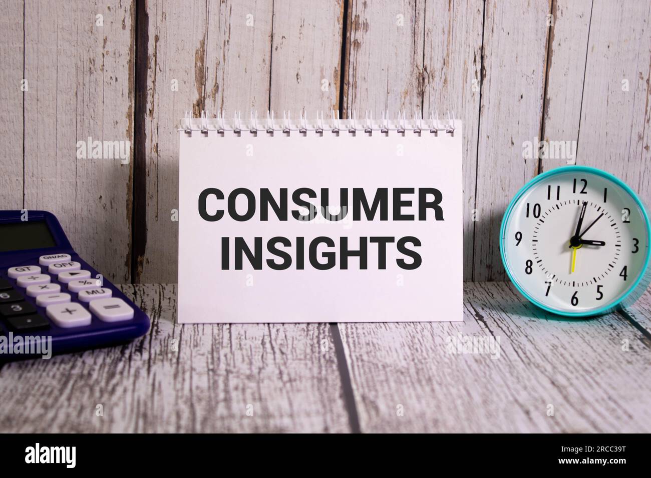 The text Consumer insights on paper notepad and calculator Stock Photo ...