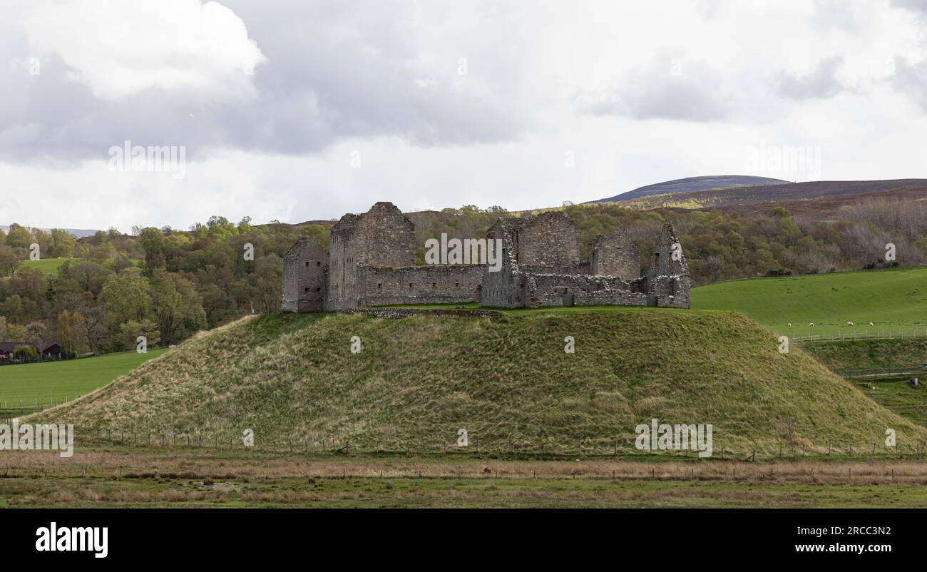 Ancient relic of a building made of grey stone on a mound covered in ...
