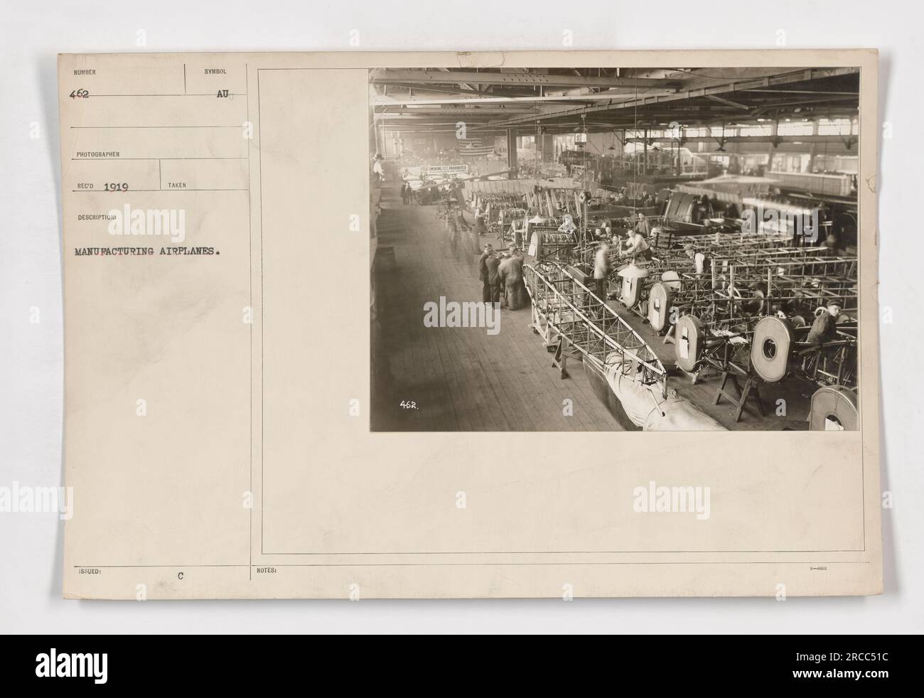 group of workers in a factory are shown assembling parts of an airplane ...