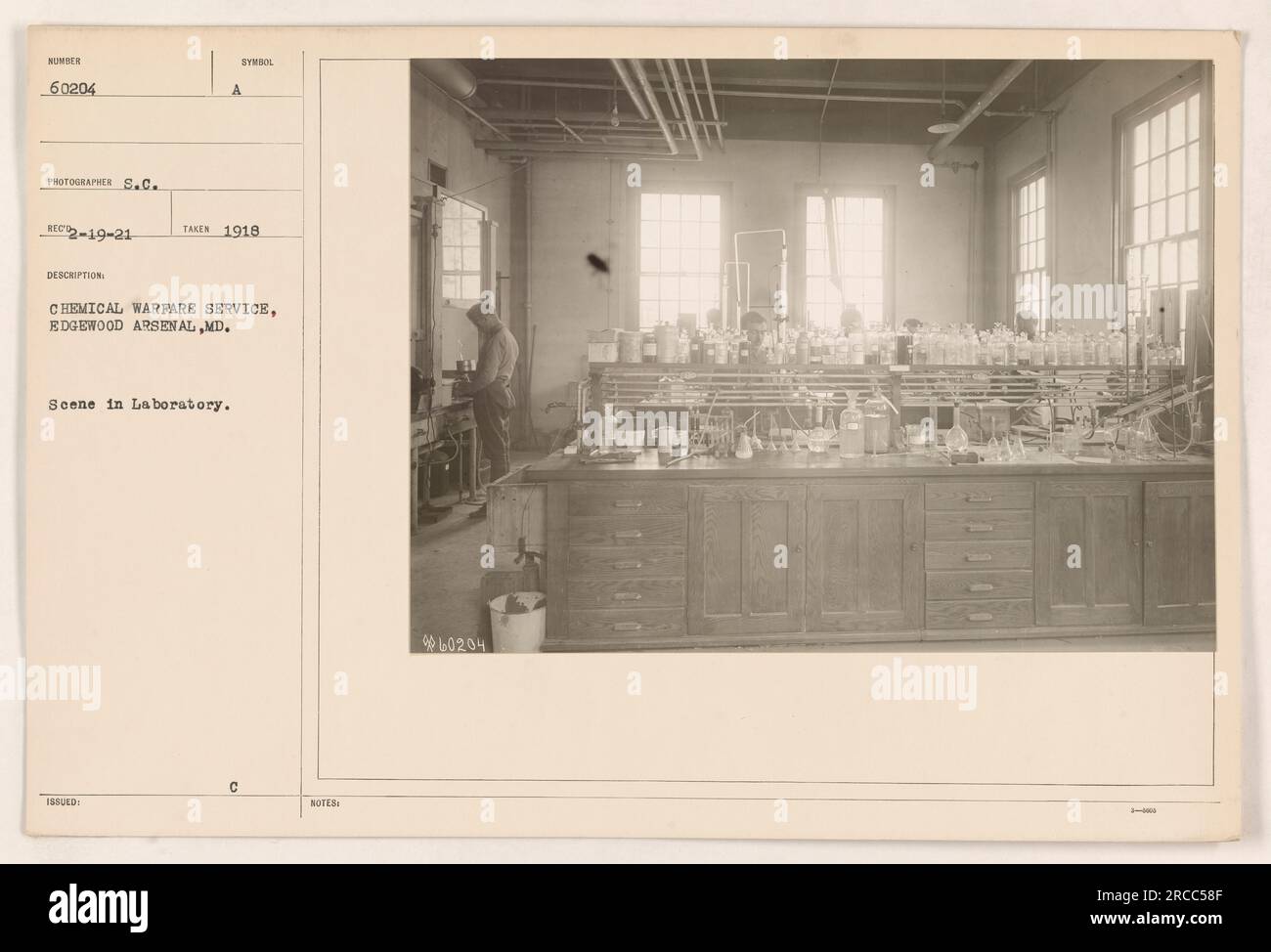 A scientist conducts experiments in a laboratory at Edgewood Arsenal in ...