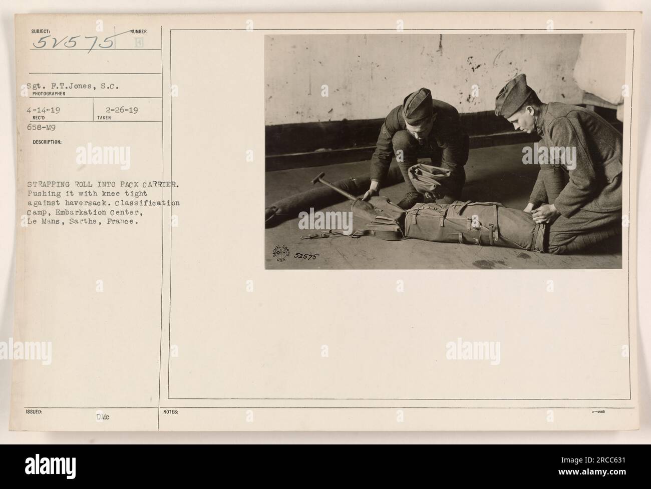 Soldier Sgt. F.T. Jones secures a roll into a pack carrier at the ...