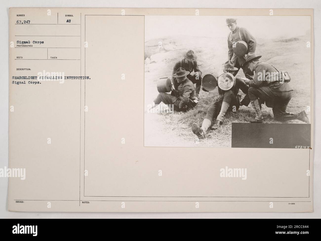 A soldier demonstrating the use of a searchlight for signaling during ...