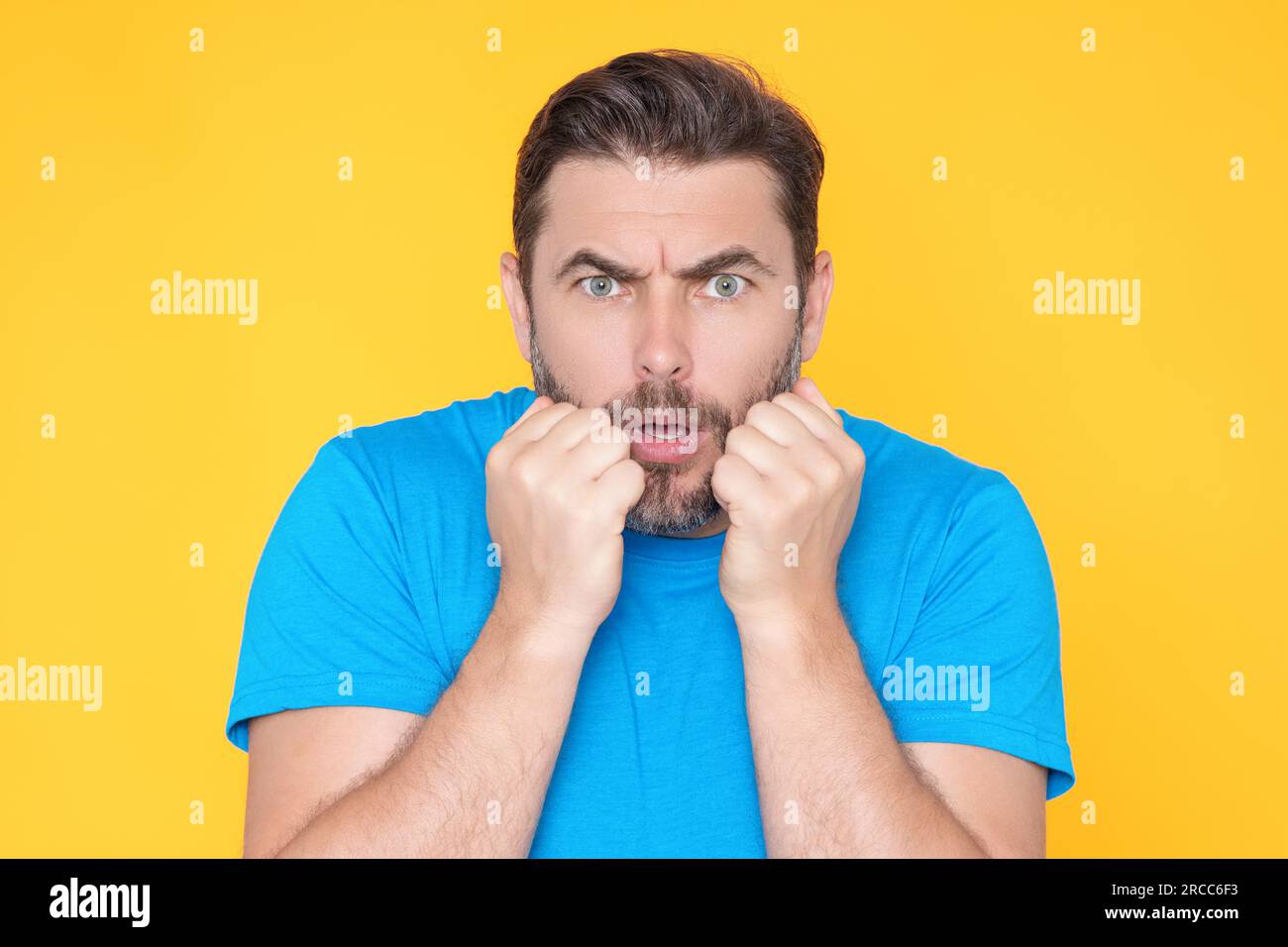 Handsome surprised man over isolated studio background afraid and ...