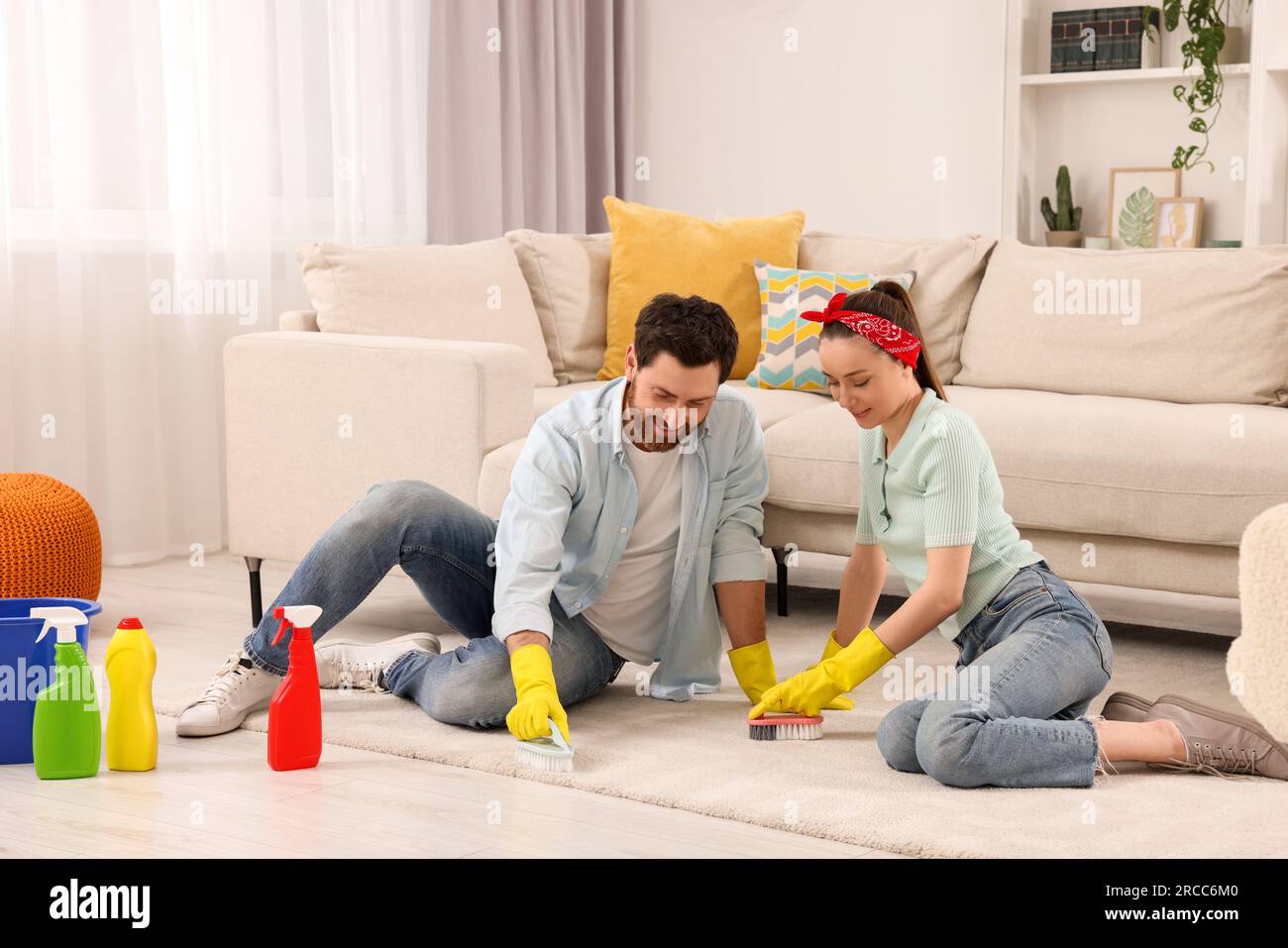Spring cleaning. Couple tidying up living room together Stock Photo - Alamy