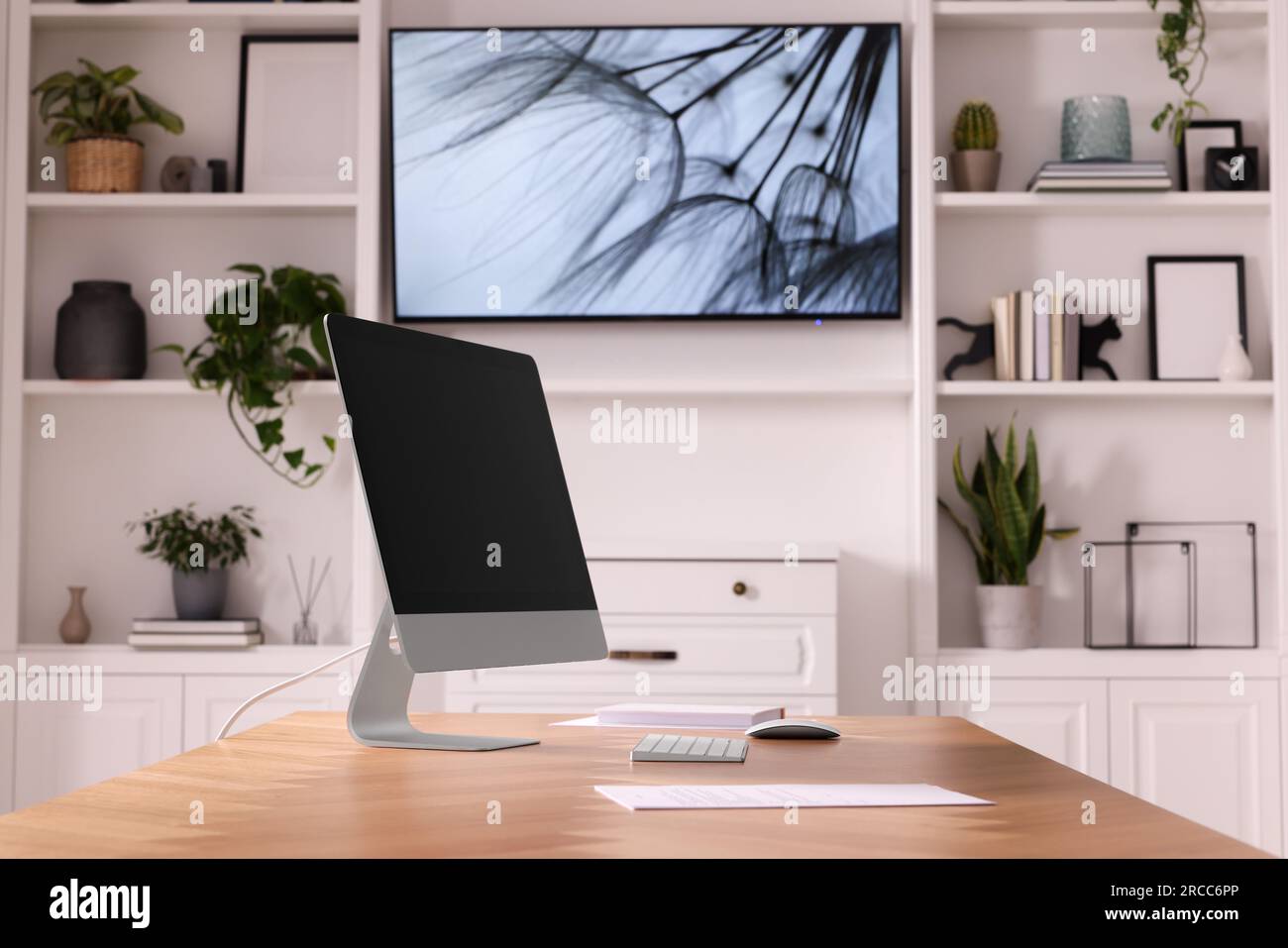 Interior design. Cosy workplace with computer near tv area Stock Photo ...