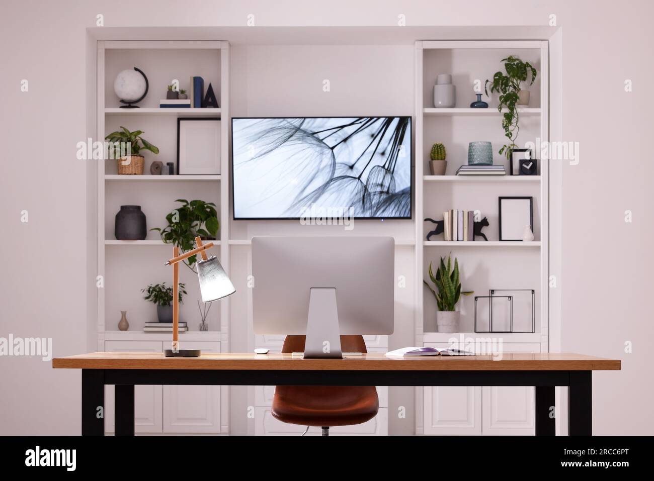 Cosy workplace with computer near tv area. Interior design Stock Photo ...