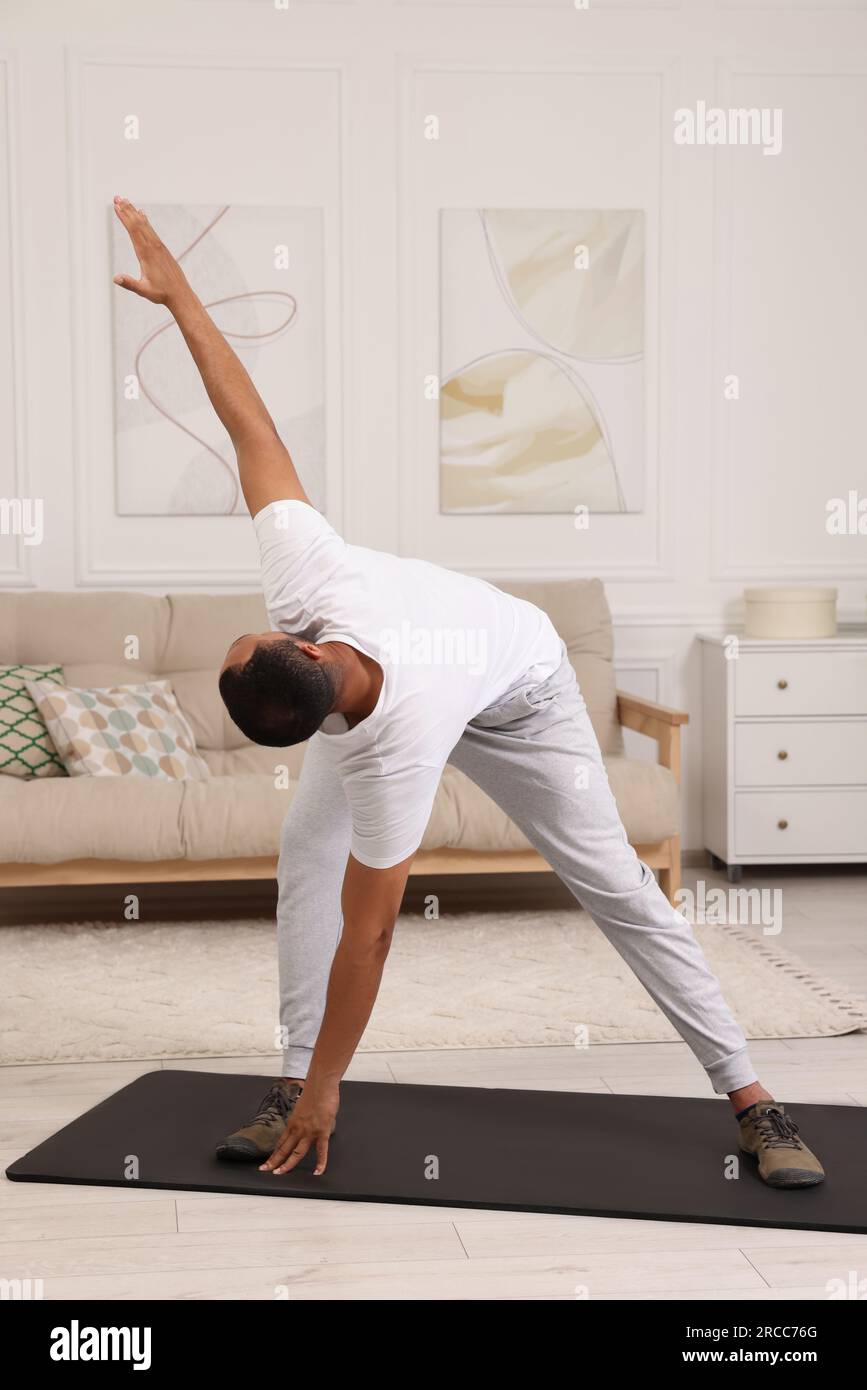 Man doing morning exercise on fitness mat at home Stock Photo - Alamy
