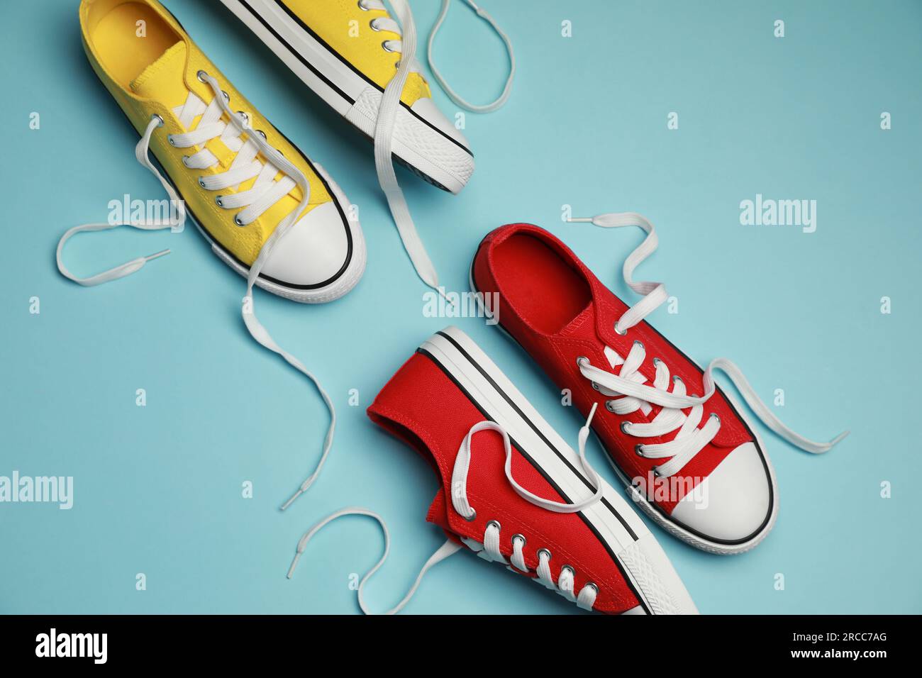 Red and yellow classic old school sneakers on light blue background ...
