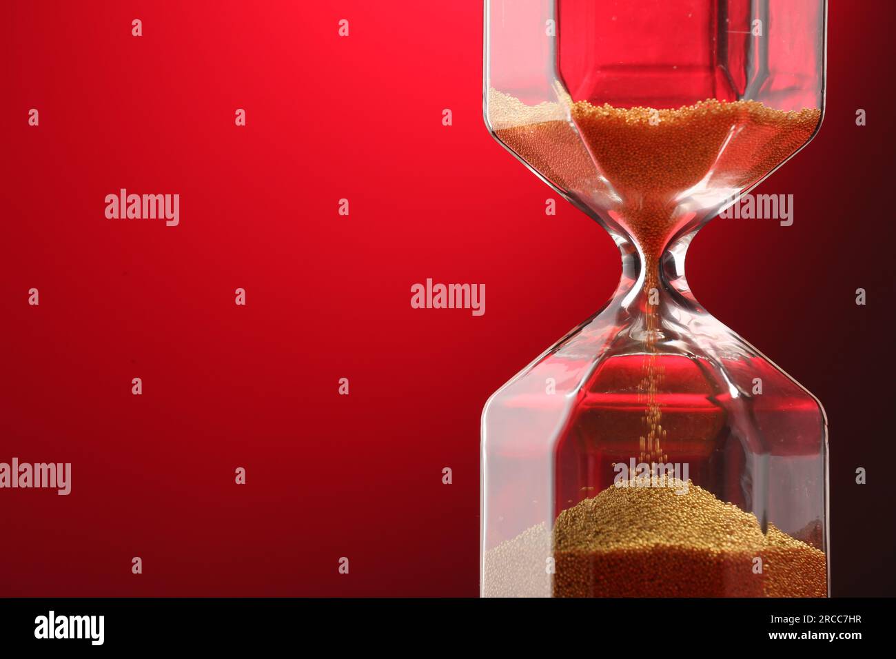 Hourglass flow on red background hi-res stock photography and images ...
