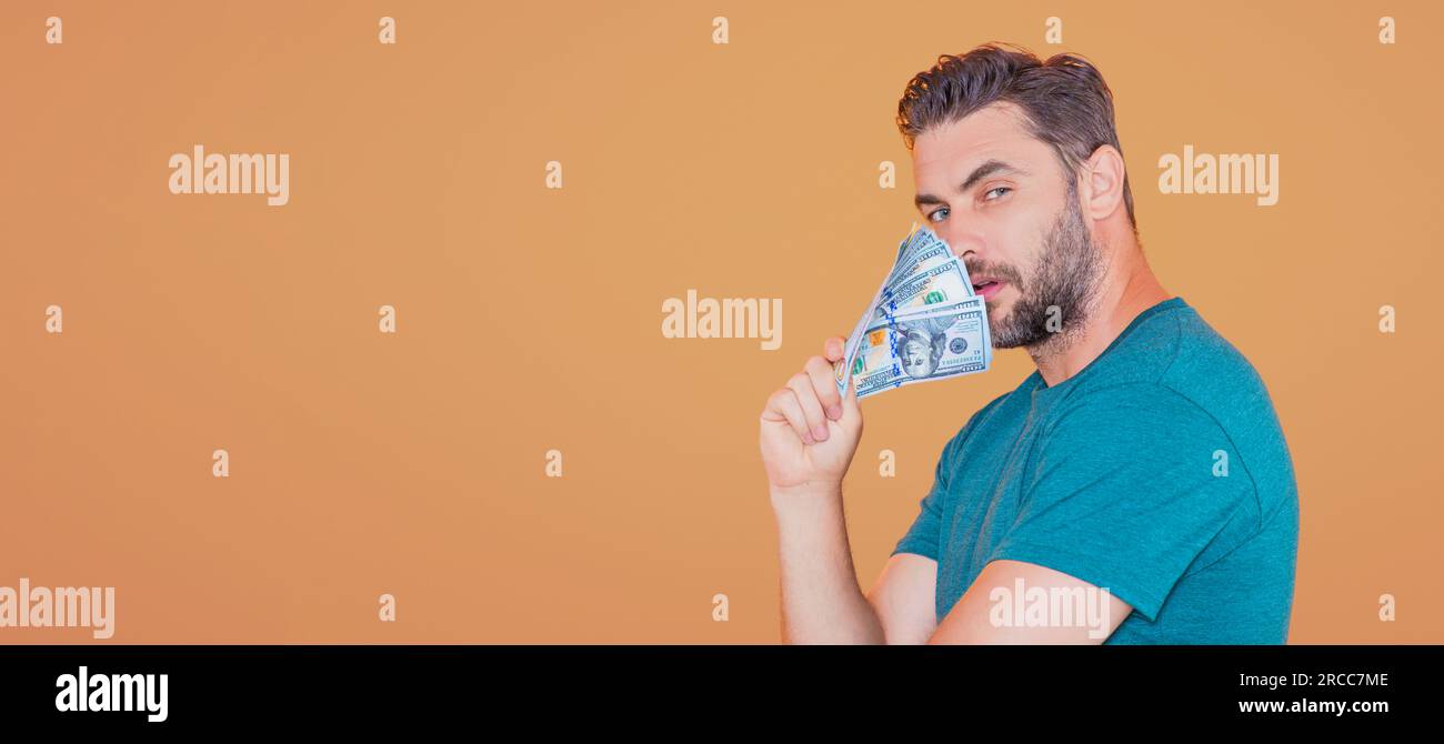 Man hold money on beige studio isolated banner background. Rich man in ...