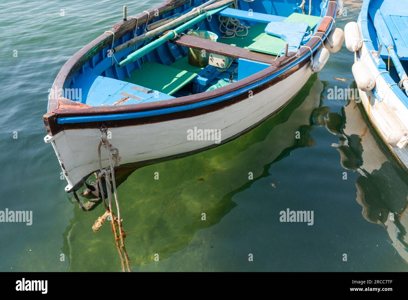 Traditional fishing dinghy tied off with rope in Portovenere,Italy ...