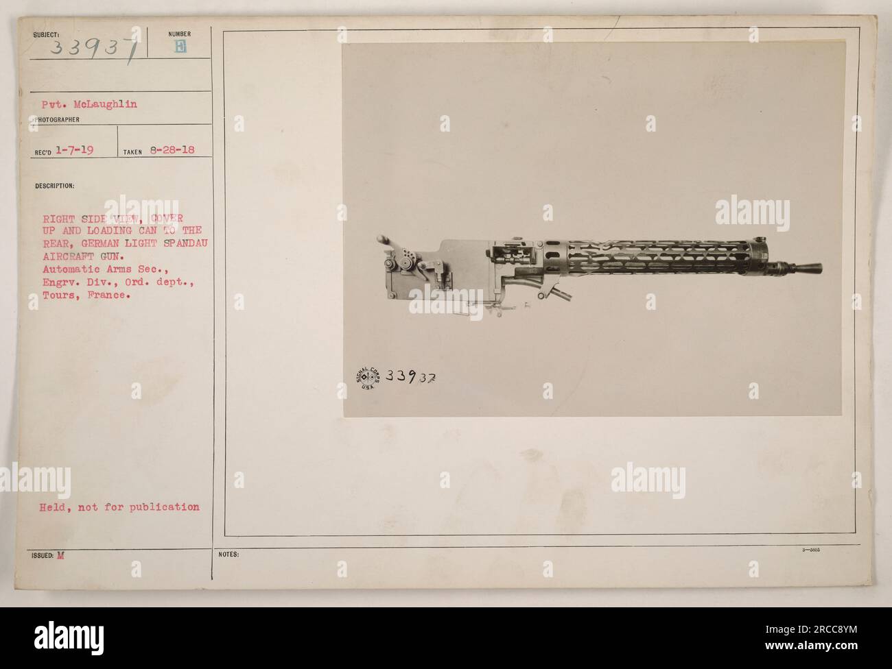 Soldier loading ammunition into a German light machine gun mounted on ...