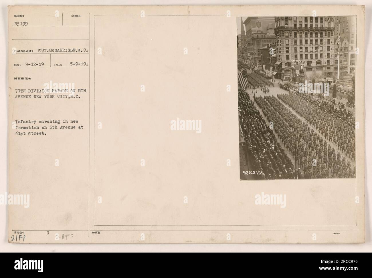 The photograph shows the 77th Division parading on 5th Avenue in New ...