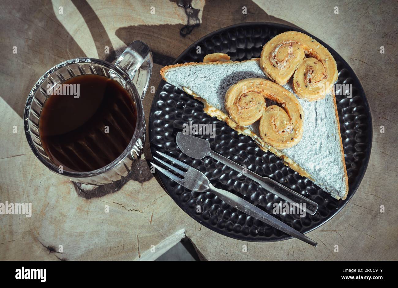 Black coffee in glass cup served with White bean butterfly shaped ...