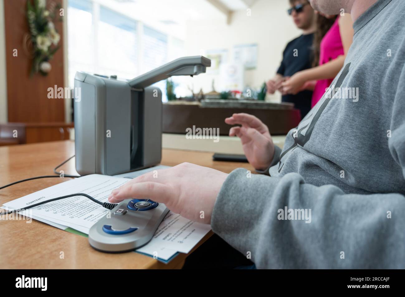 A visually impaired man uses a scanning and reading machine Stock Photo ...
