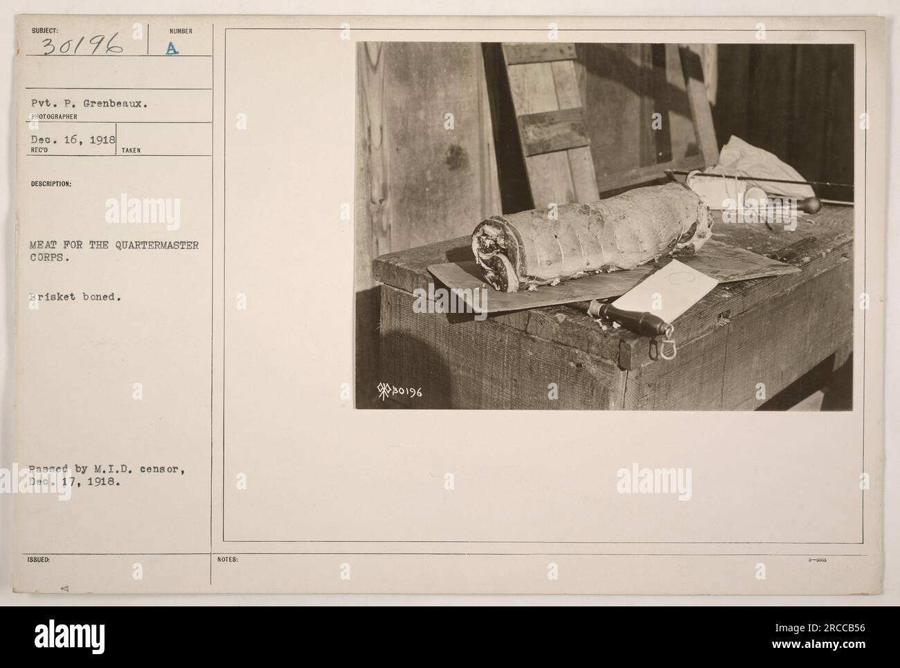Soldier Pvt. P. Grenbeaux poses with a brisket that has been boned on ...
